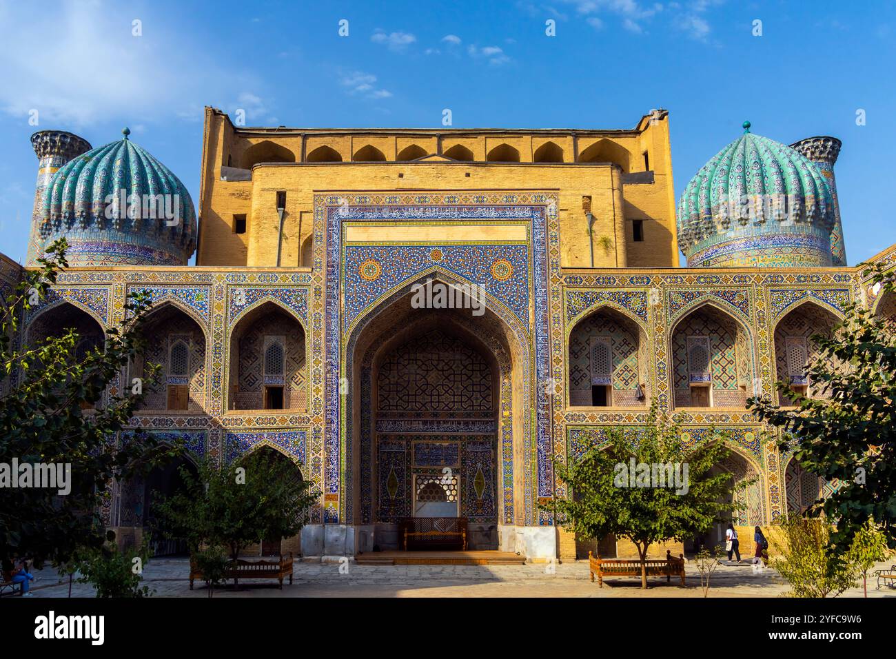 Courtyard of the Sher-Dor Madrasah the walls are decorated with bright ...