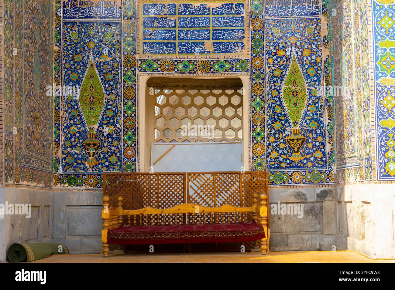 Courtyard of the Sher-Dor Madrasah the walls are decorated with bright ...