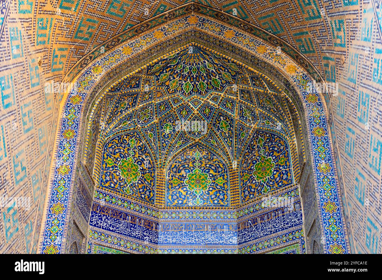 Courtyard of the Sher-Dor Madrasah the walls are decorated with bright ...