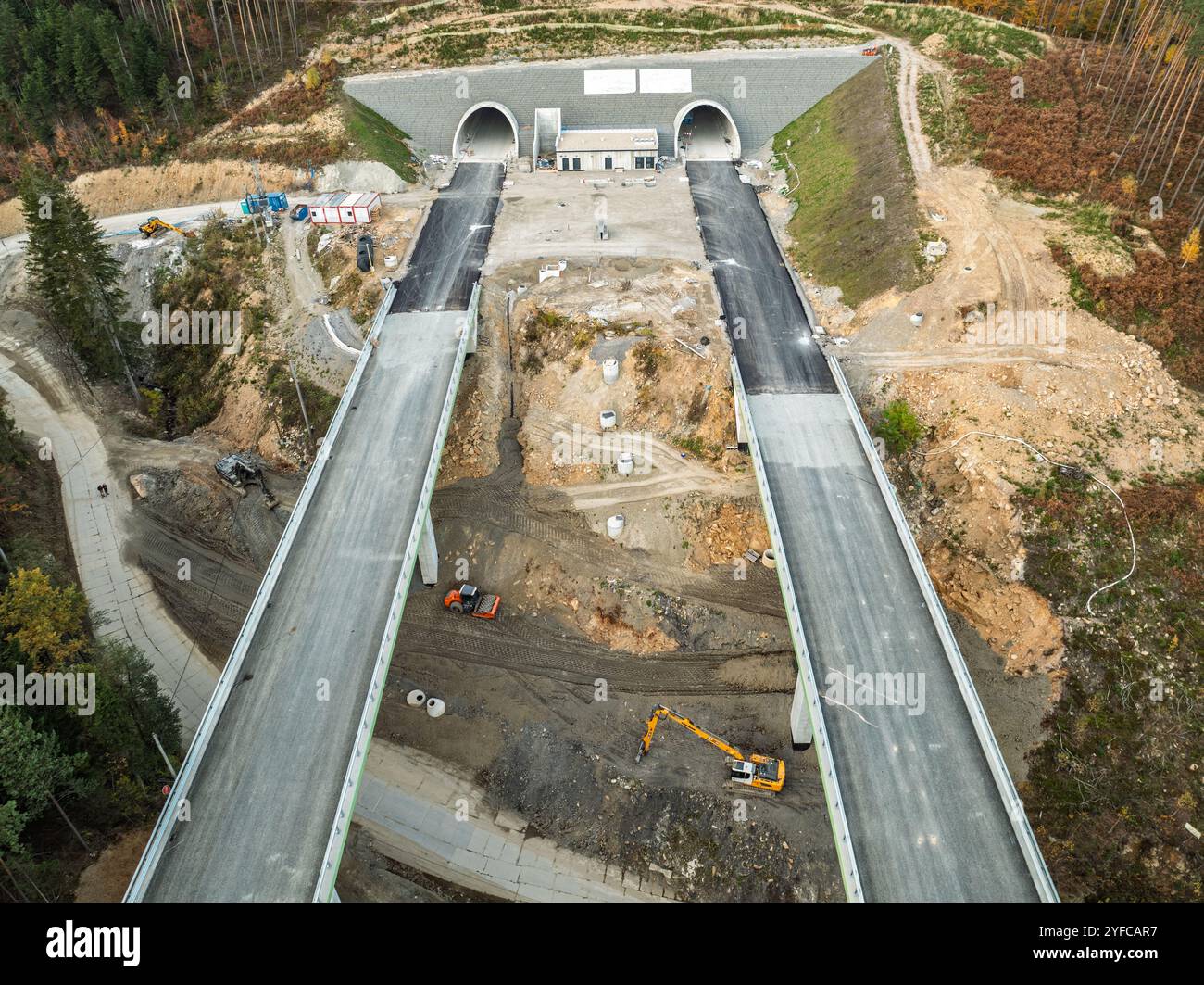Aerial drone view of unfinished highway construction site in mountains ...
