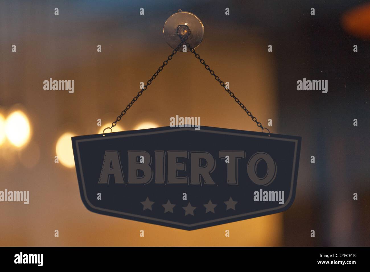 Open sign in a window with written in Spanish “Abierto”, meaning “Open ...