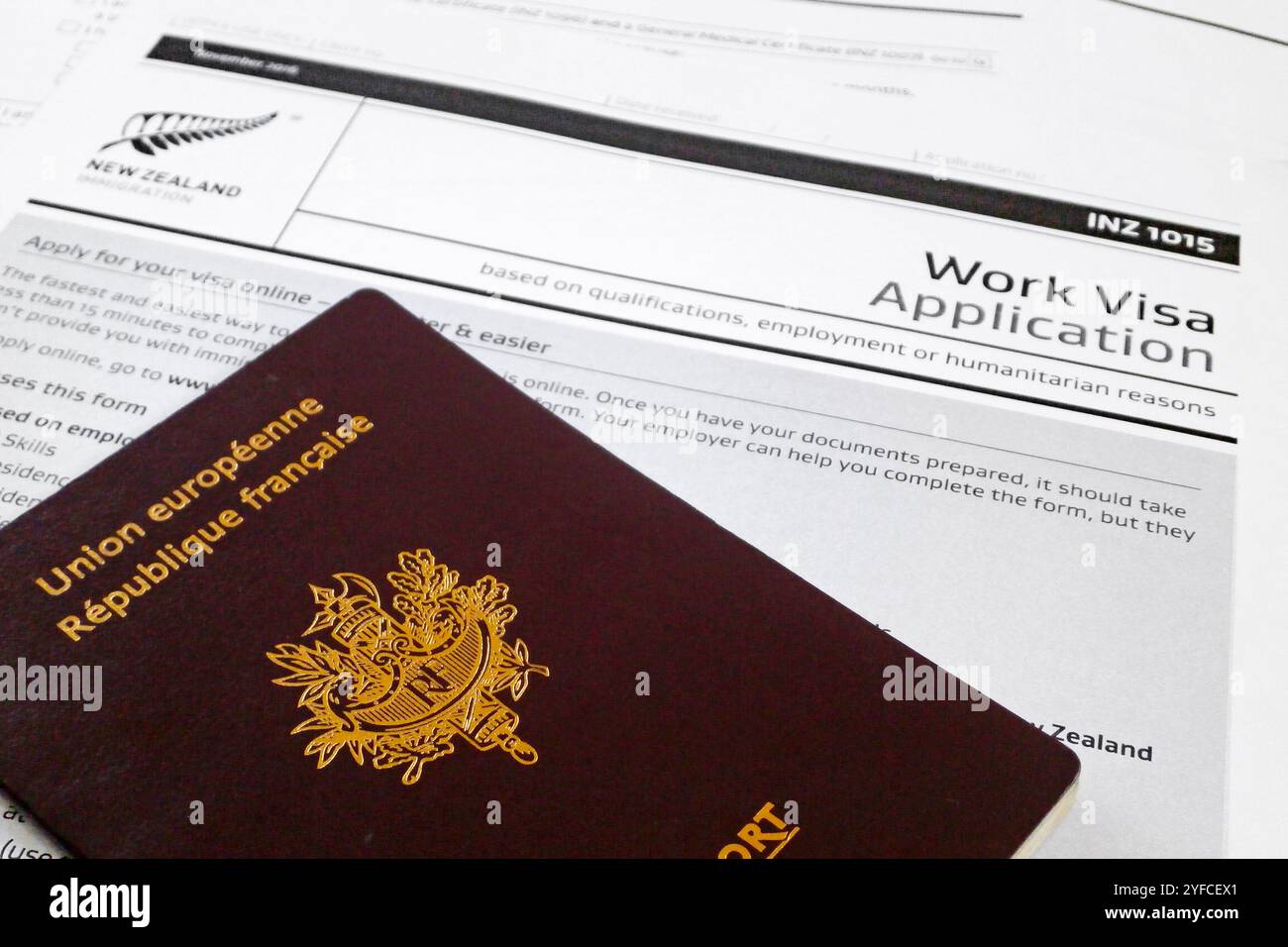 French passport on top of a work visa application form to work in New ...