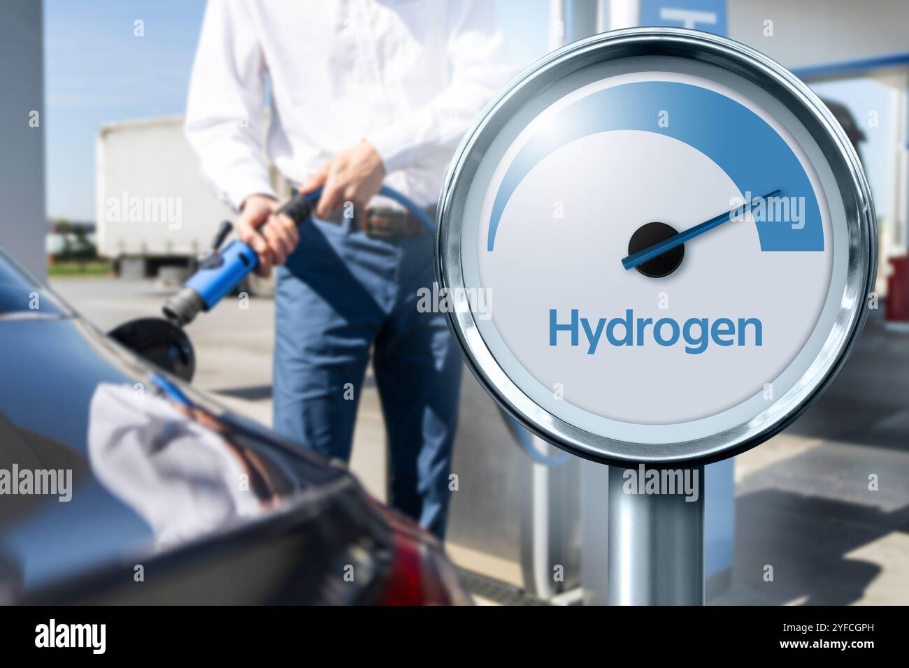 Man holds a hydrogen fueling nozzle on a hydrogen filling station ...