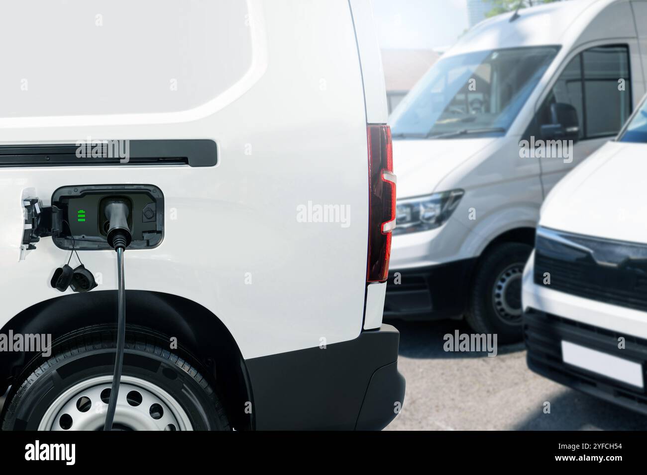 Electric delivery van with connected charging cable Stock Photo - Alamy