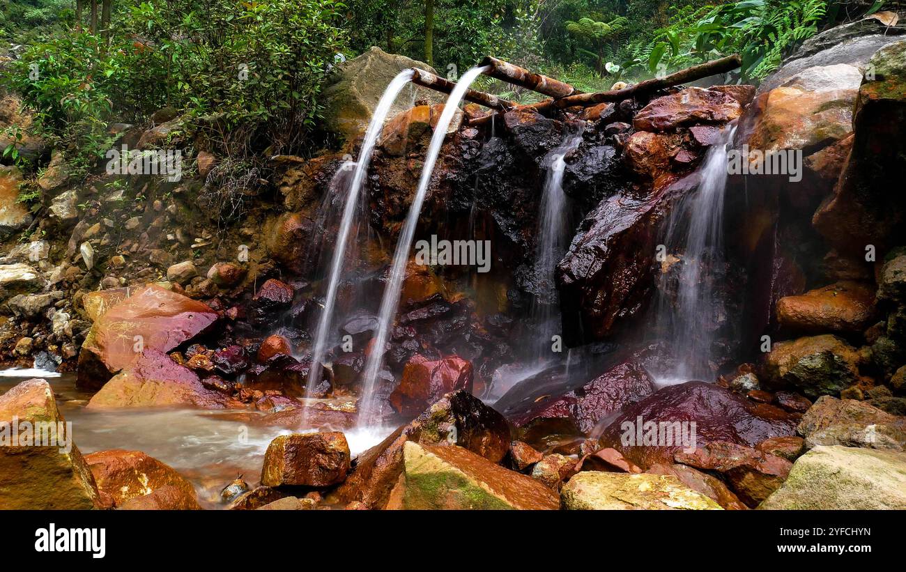 A hot spring flowing from bamboo. The hot water comes from the active ...