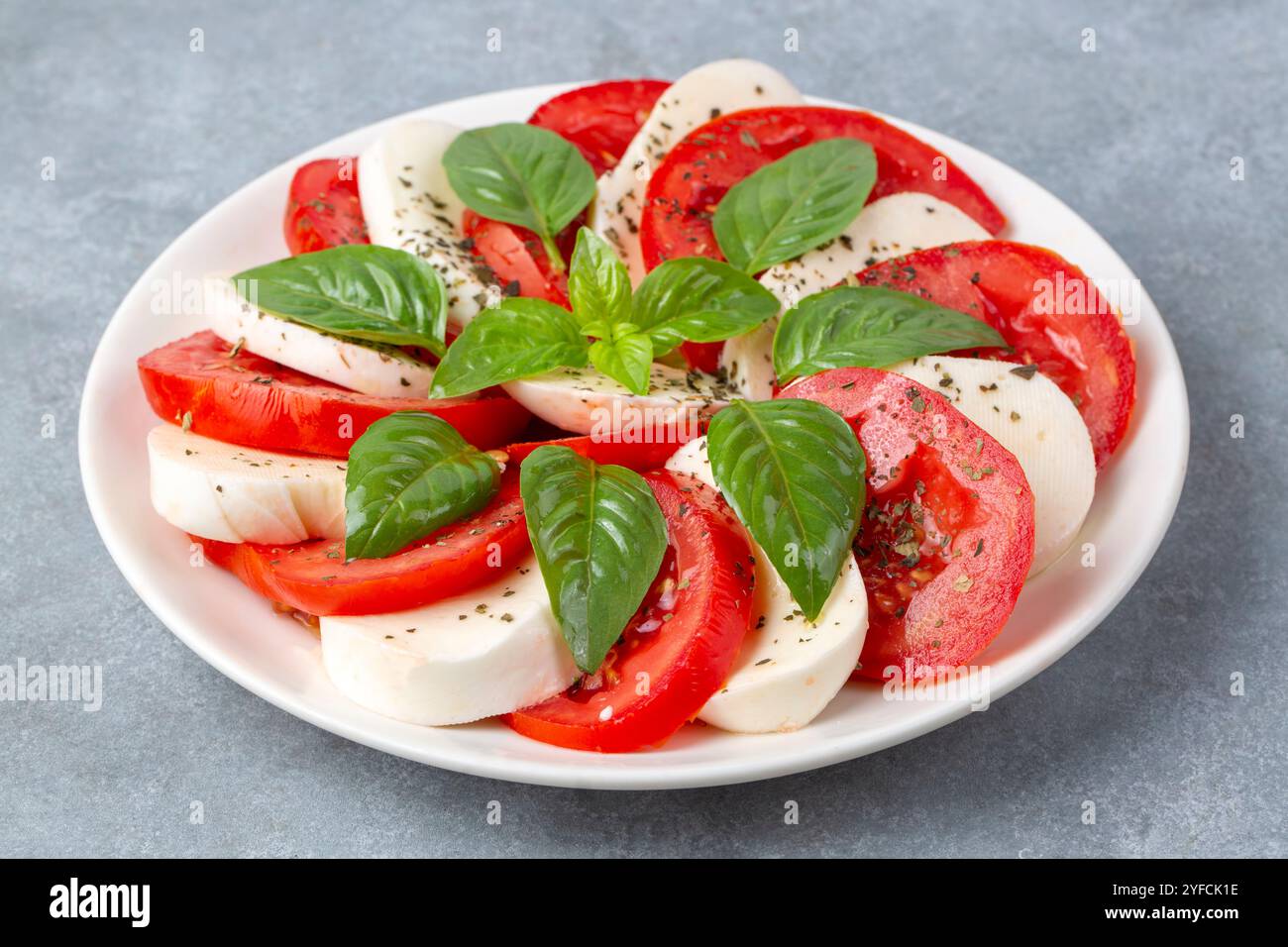 Italian caprese salad with sliced tomatoes, mozzarella, basil, olive ...