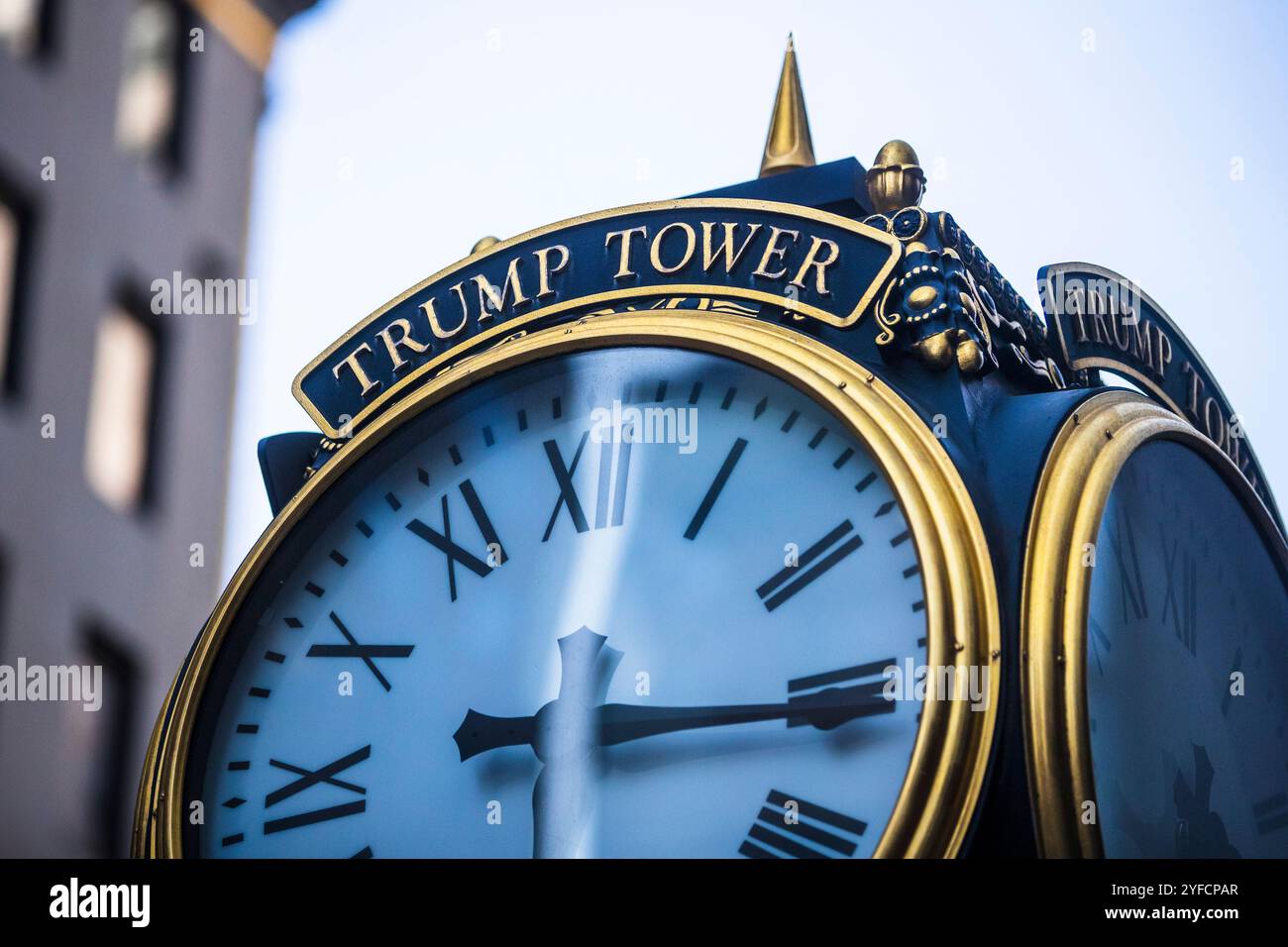 A close-up of the Trump Tower clock in New York City, showcasing its Roman numerals and ...