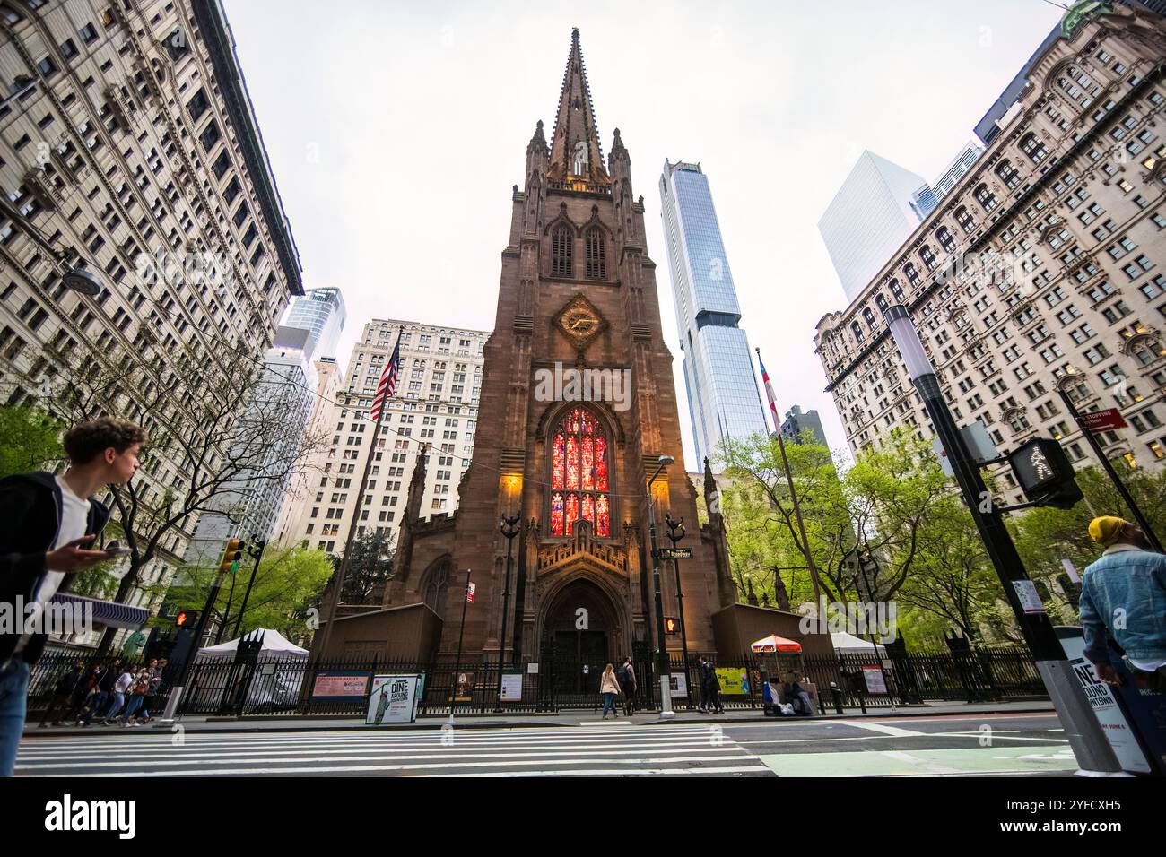A frontal view of Trinity Church in New York City, surrounded by modern ...