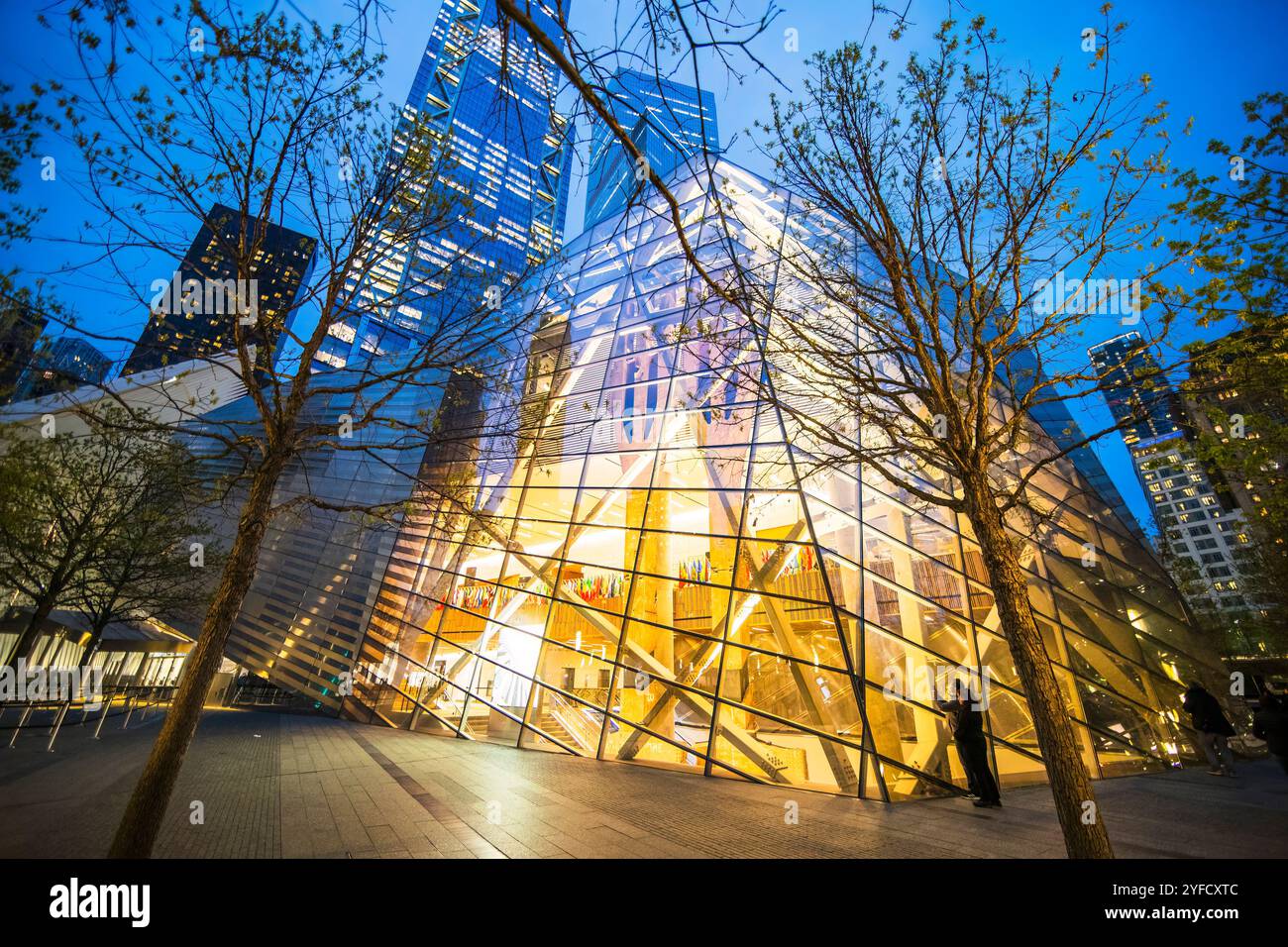 A stunning evening view of the National September 11 Museum Pavilion in New York City, featuring ...