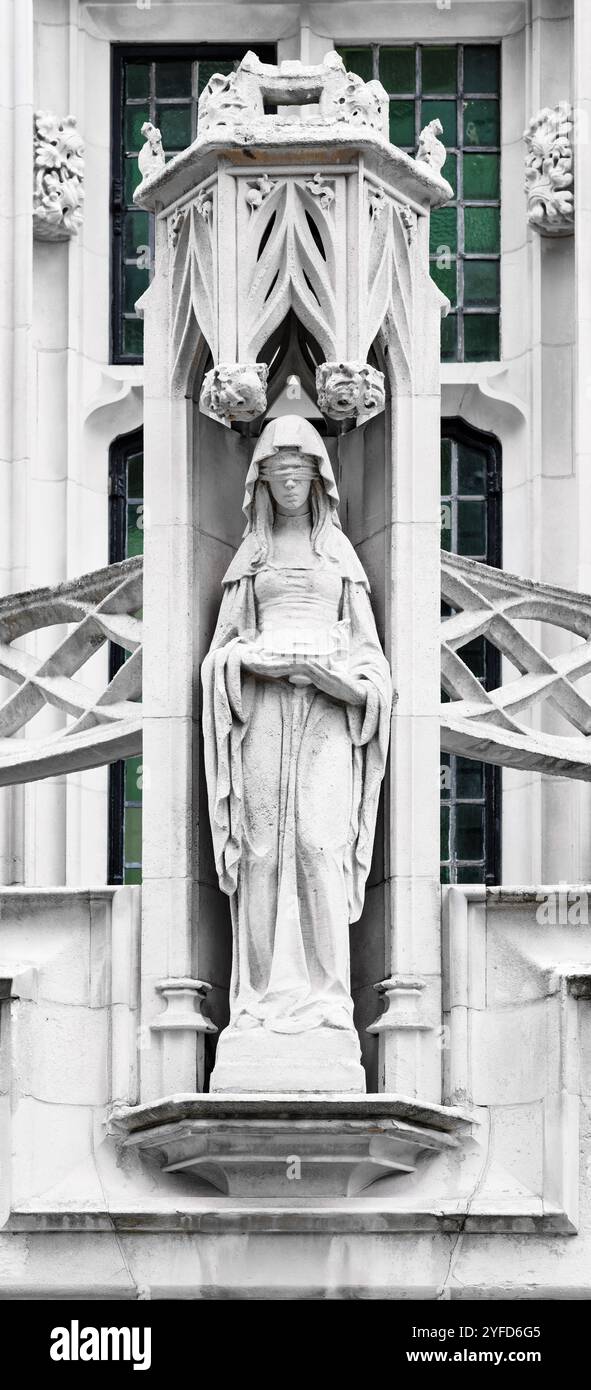 Statue of blindfolded person, by sculptor Henry Fehr, on the facade of ...