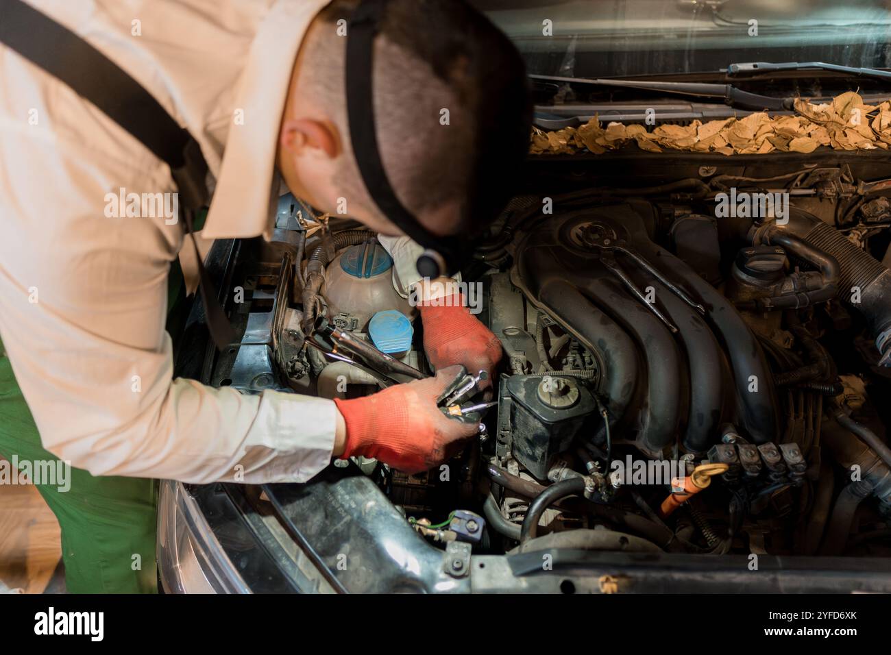 Mechanic Performing Engine Repairs with Diagnostic Tools in a Workshop ...