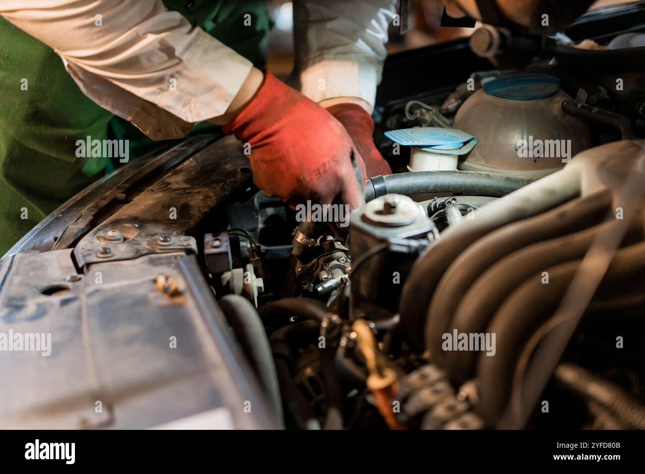 A Mechanic Diagnosing a Car Engine in a Workshop Stock Photo - Alamy