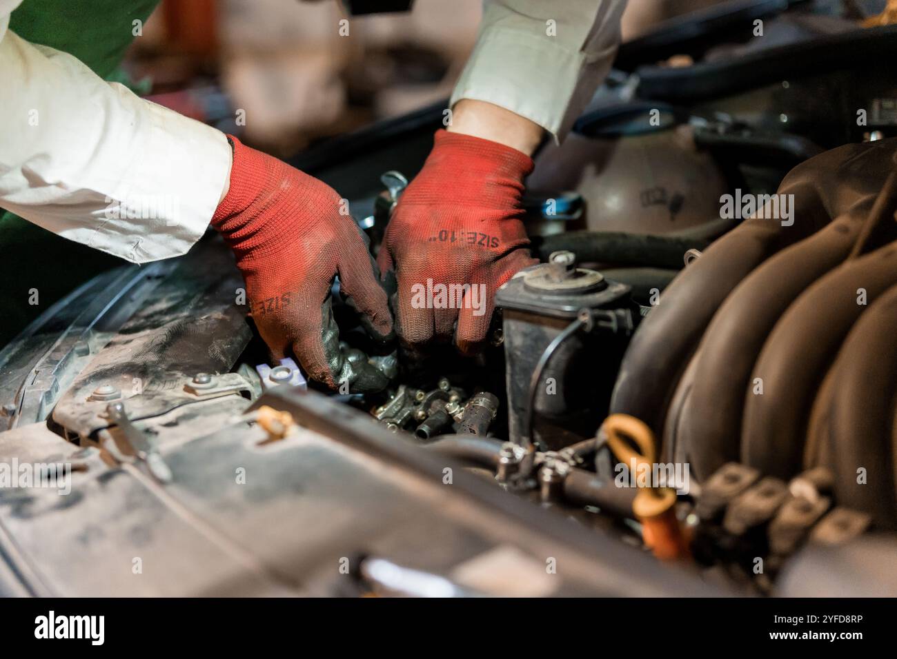 Mechanic Repairing Engine Components with Red Work Gloves Stock Photo ...