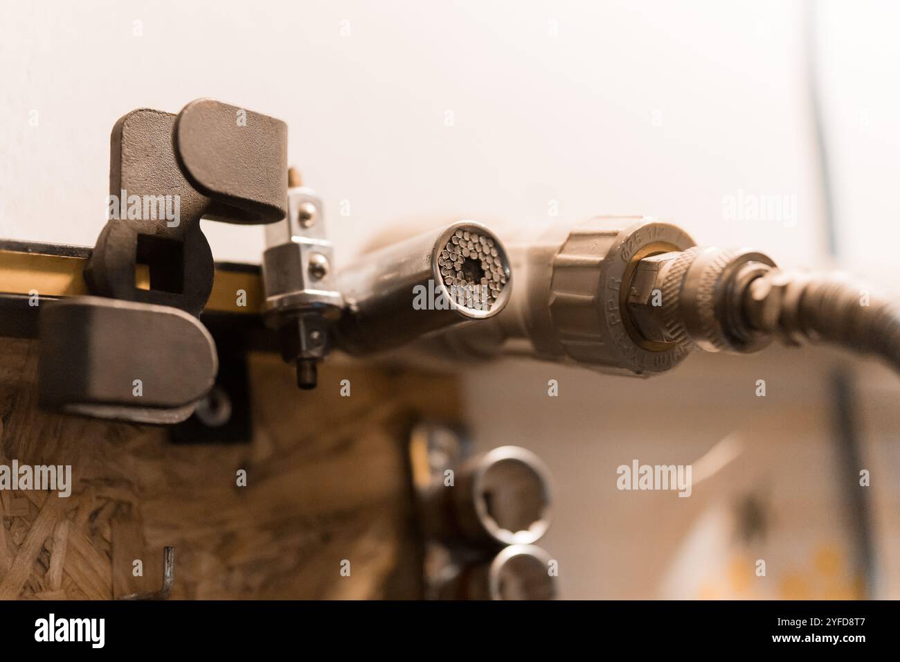 Close-Up of a Metal Pipe Fitting and Clamp in a Workshop Setting Stock ...