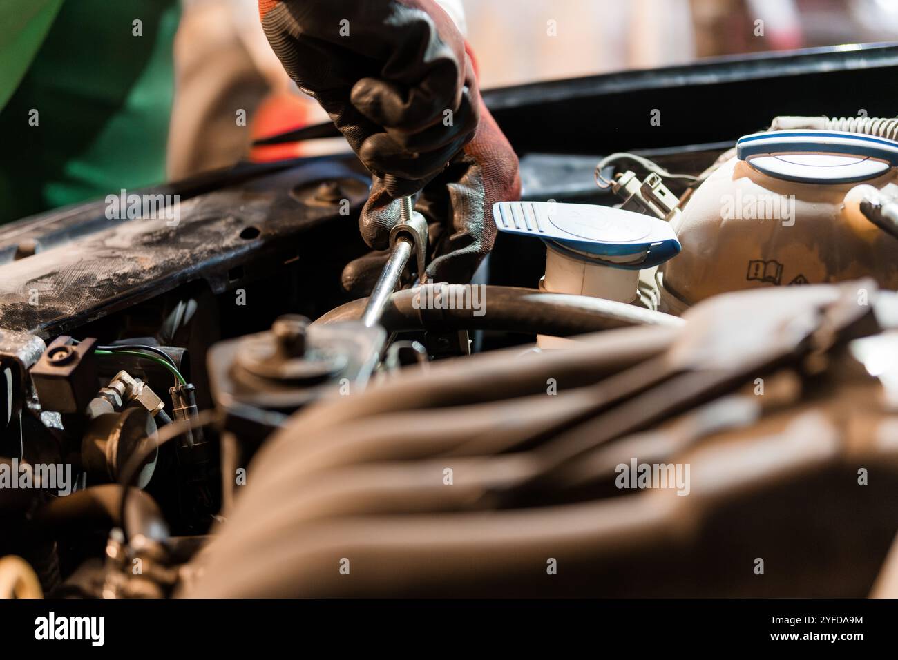 Mechanic Using Socket Wrench Underneath Car Hood for Engine Repair ...
