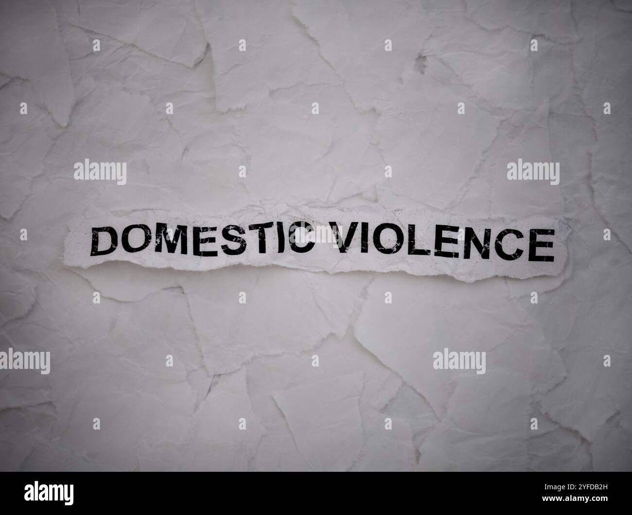 Crumpled piece of a paper with words Domestic Violence on torn white ...
