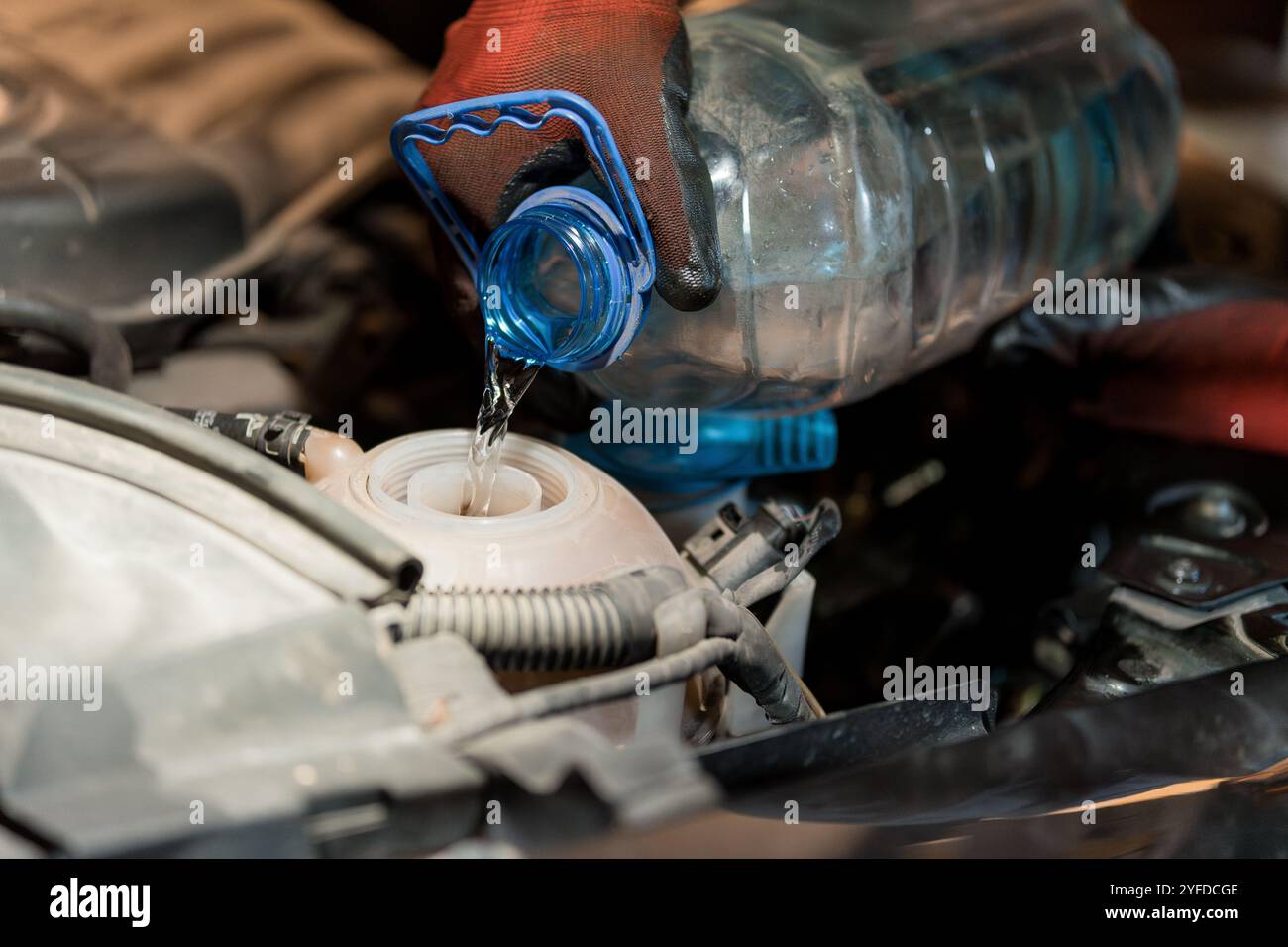 Car Maintenance: Pouring Coolant into the Reservoir Stock Photo - Alamy