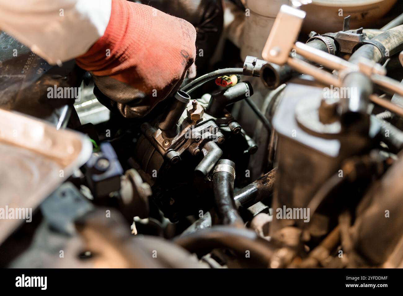 Car Mechanic Working on Fuel Injector in Engine Compartment Stock Photo ...