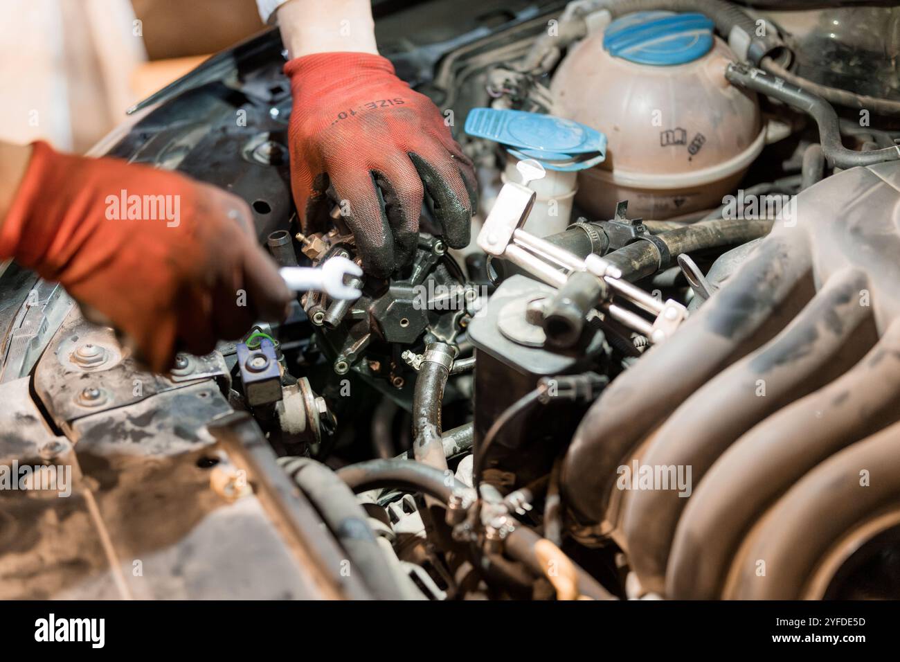Mechanic Working on Car Engine with Tools Stock Photo - Alamy