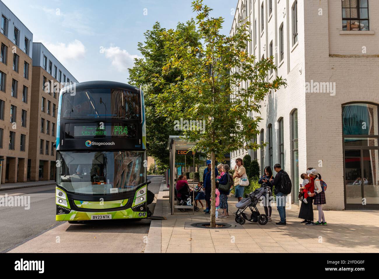 A queue of people are waiting to board the Park and Ride double decker ...