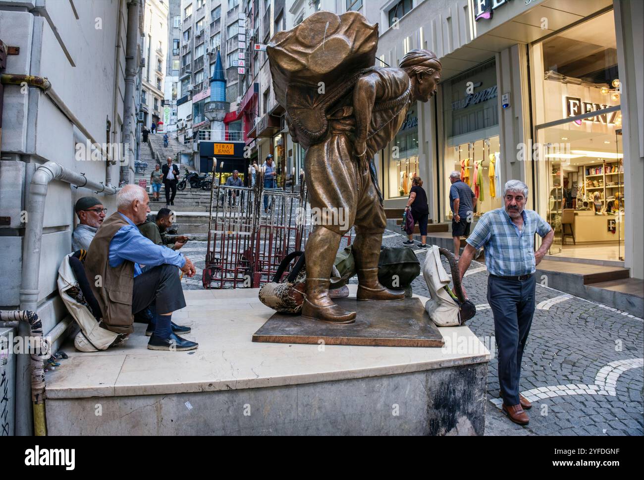 Porters resting beside the Porter statue, Istanbul, Turkey Stock Photo ...