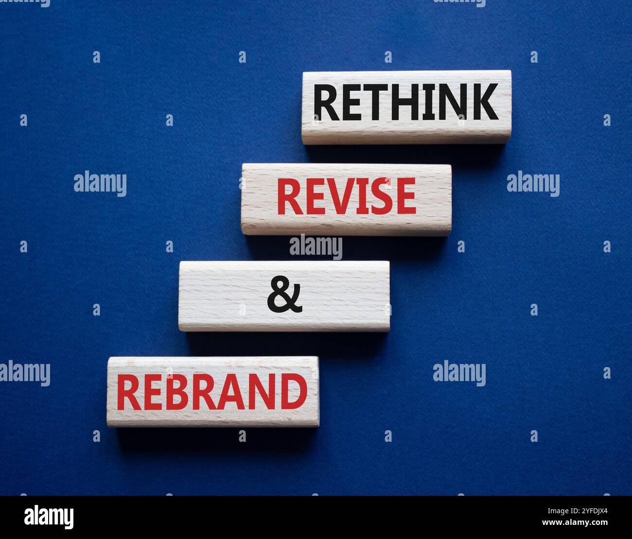 Rethink Revise and Rebrand symbol. Wooden blocks with words Rethink Revise and Rebrand ...