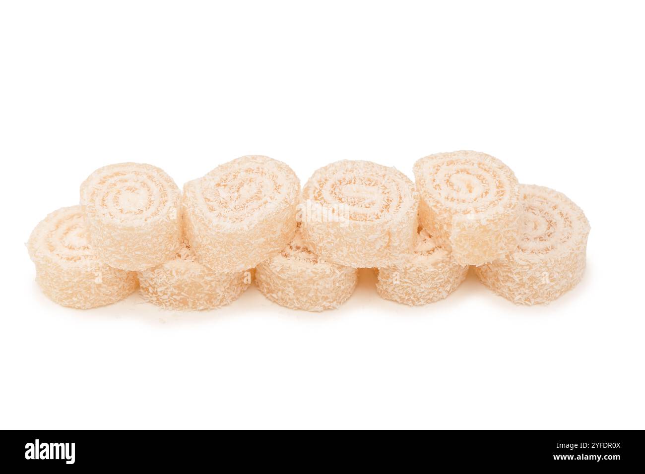 Coconut candy roll isolated on a white background Stock Photo - Alamy