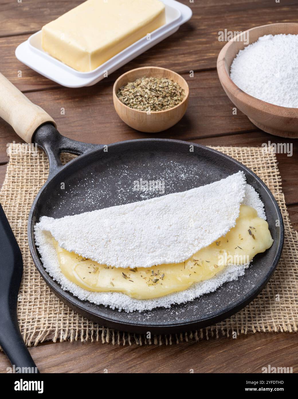Traditional brazilian cheese stuffed tapioca on a pan with ingredients ...