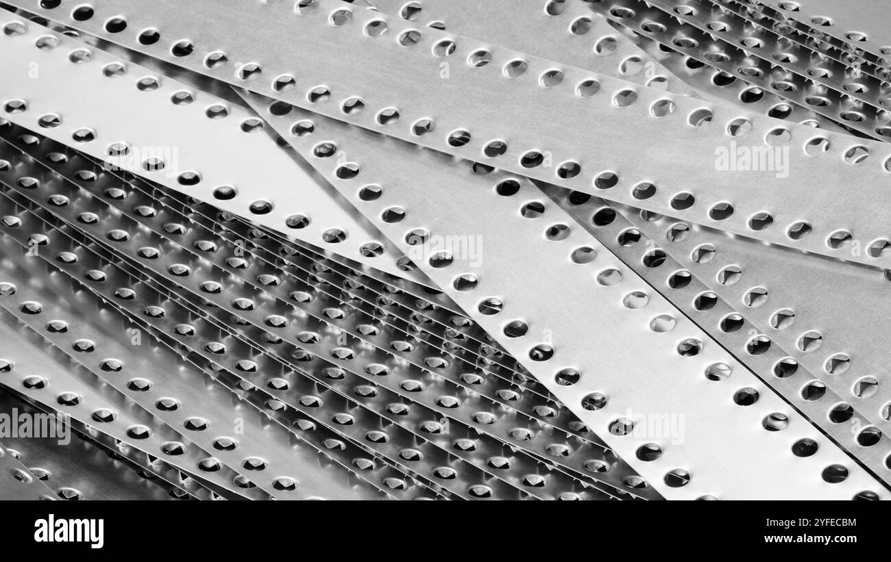 A pile of metal pieces with holes in them. The holes are of different ...