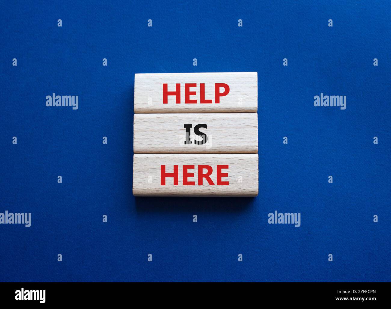 Help is here symbol. Wooden blocks with words Help is here. Beautiful ...