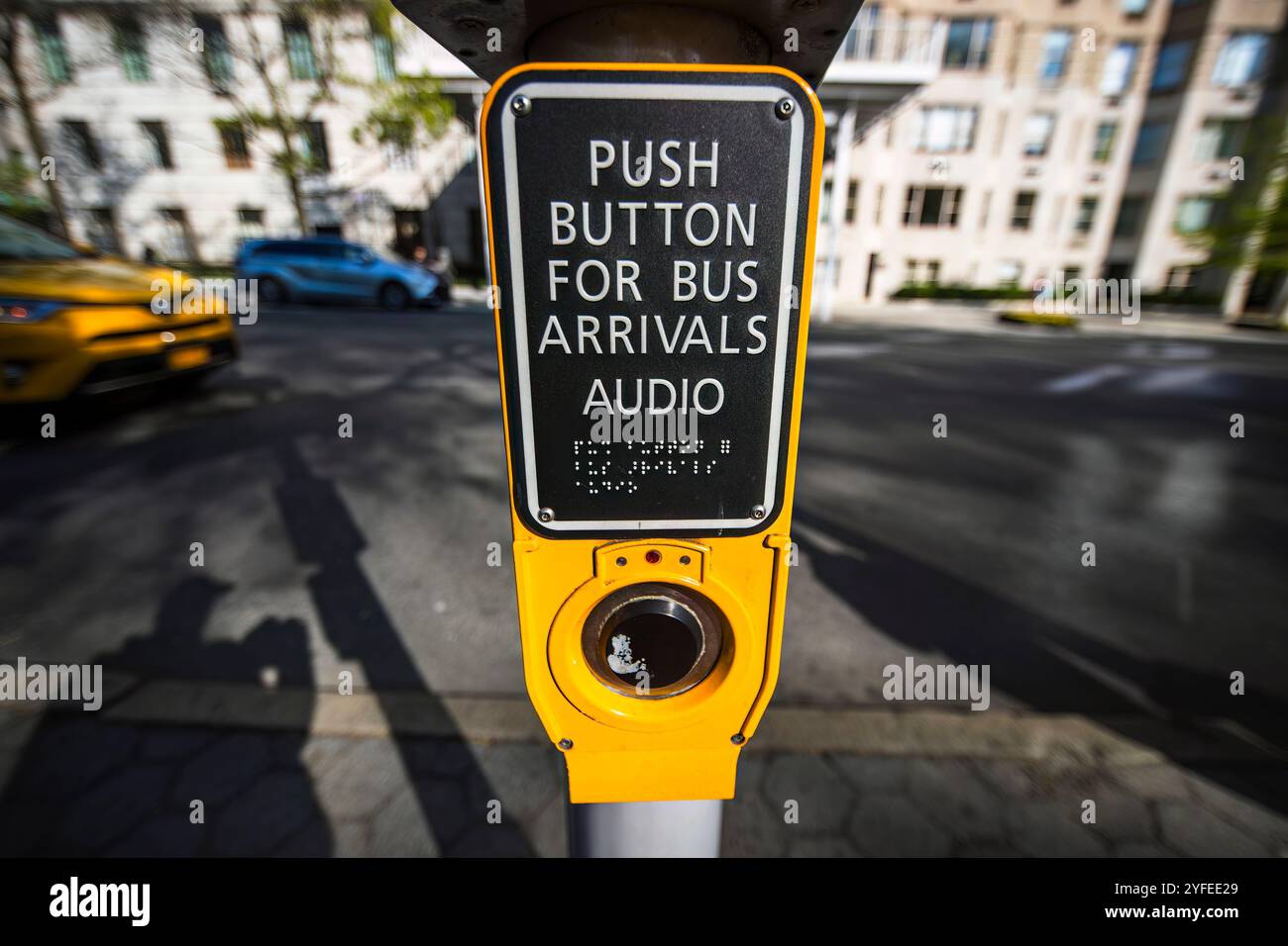 A close-up of a pedestrian push button for bus arrivals audio, mounted ...