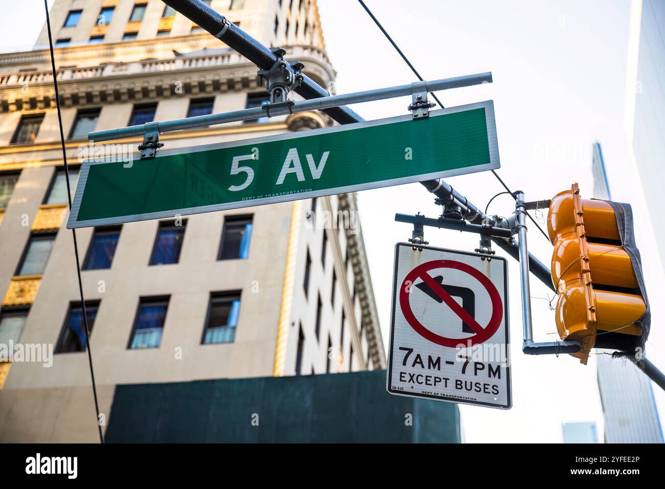 A street sign for Fifth Avenue in New York City is mounted above a ...