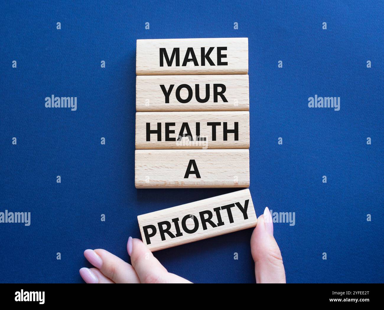 Health symbol. Wooden blocks with words Make your health a Priority ...
