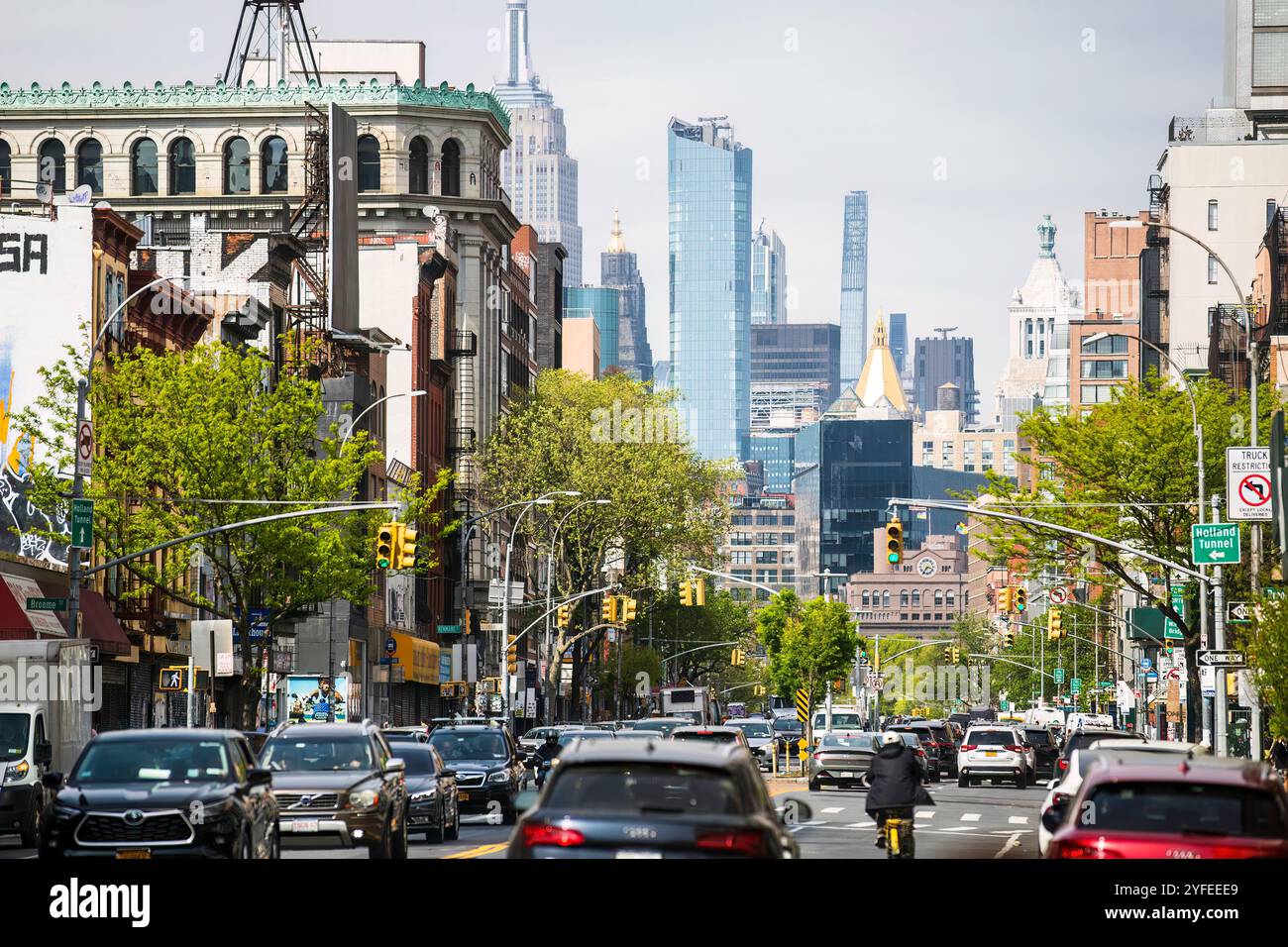 A busy street in New York City with cars, cyclists, and traffic lights ...