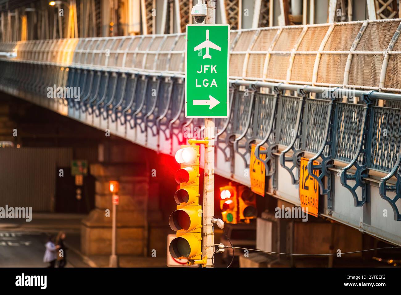 A green airport directional sign pointing to JFK and LGA airports is ...