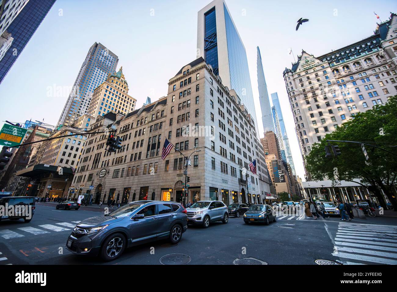 A bustling intersection in New York City near Fifth Avenue, featuring ...
