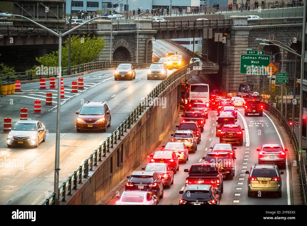 Heavy traffic on a New York City highway at dusk, with cars' red brake ...