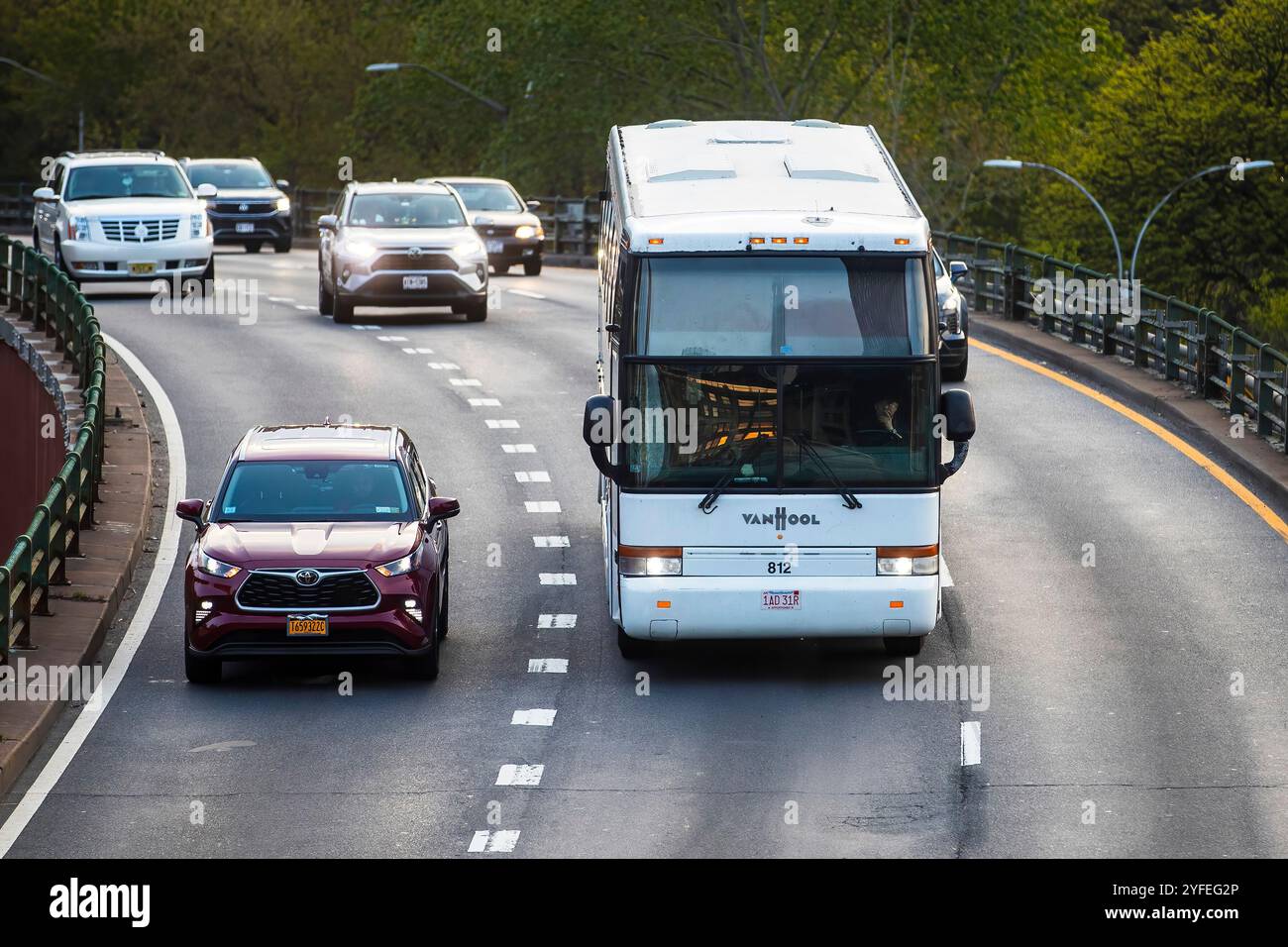 White Van Hool coach bus driving on a curved highway alongside other ...