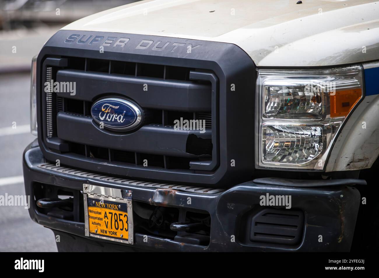 Front view of a Ford Super Duty truck grille with New York license ...