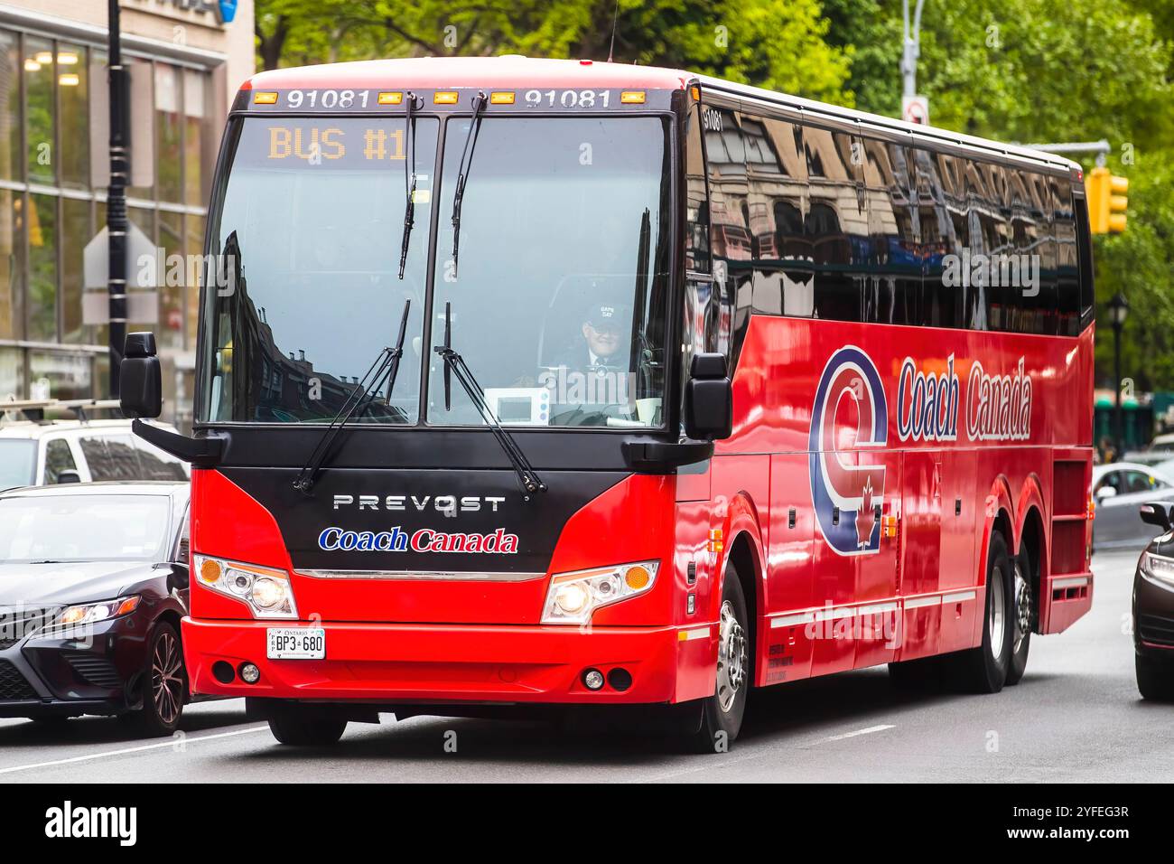 Red Coach Canada bus driving through a New York City street, offering ...