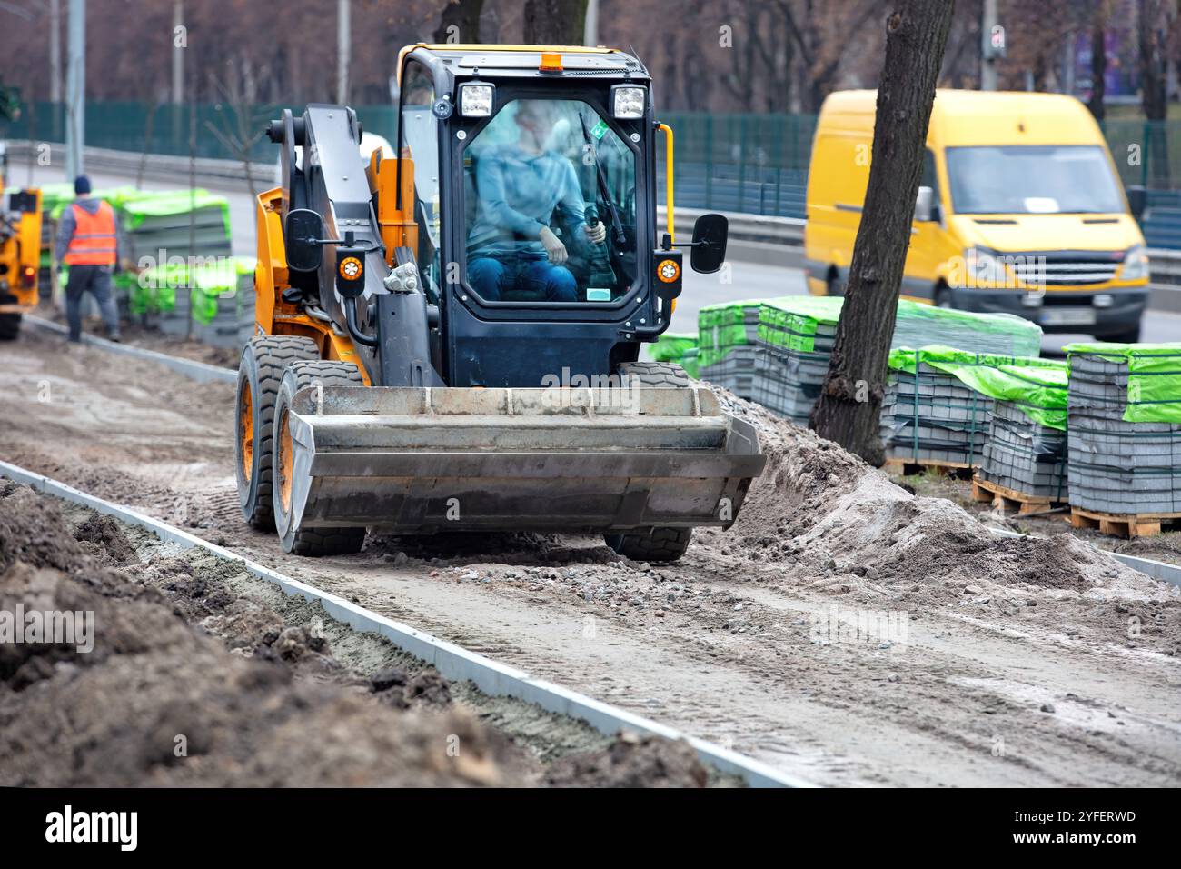 Construction site with bulldozer, machinery operated by worker, road ...