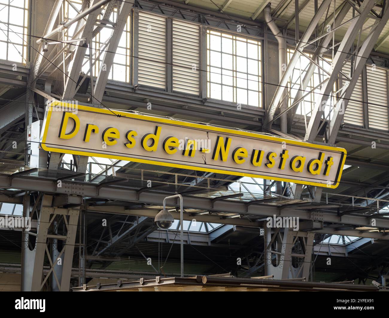 Dresden-Neustadt train station sign close up. Big yellow signage with ...