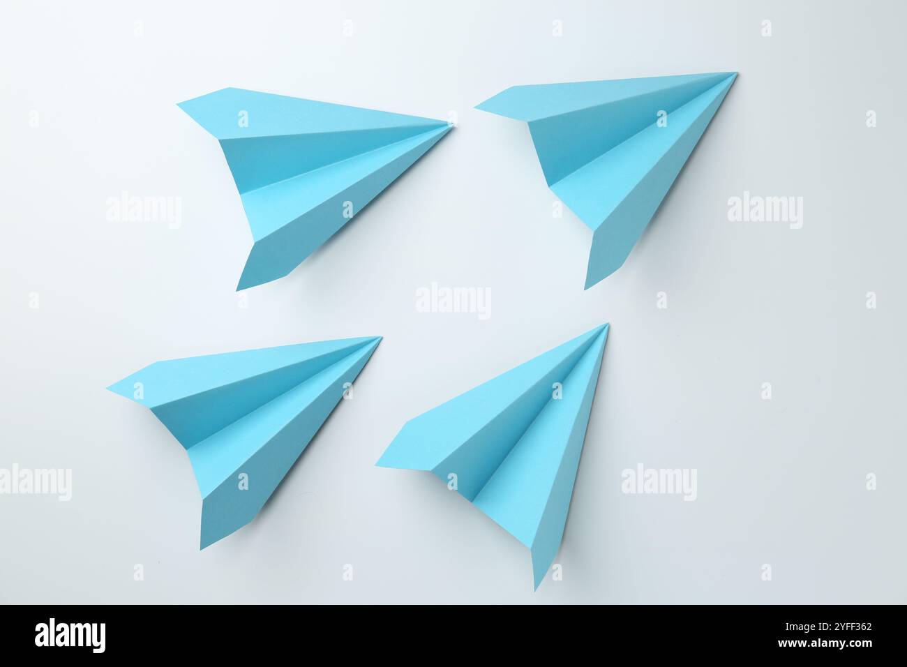 Handmade light blue paper planes on white background, top view Stock ...