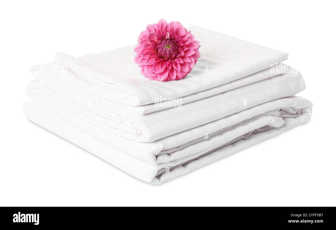 Stacked bed linens and pink flower on white background Stock Photo - Alamy