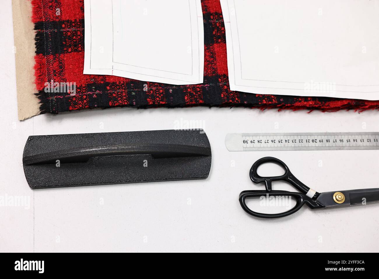 Piece of fabric, measurements, scissors and other tools on white table ...