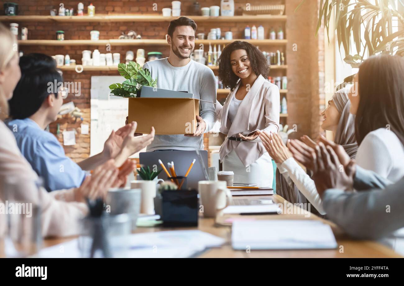 Young multiracial team welcoming cheerful guy newcomer Stock Photo - Alamy