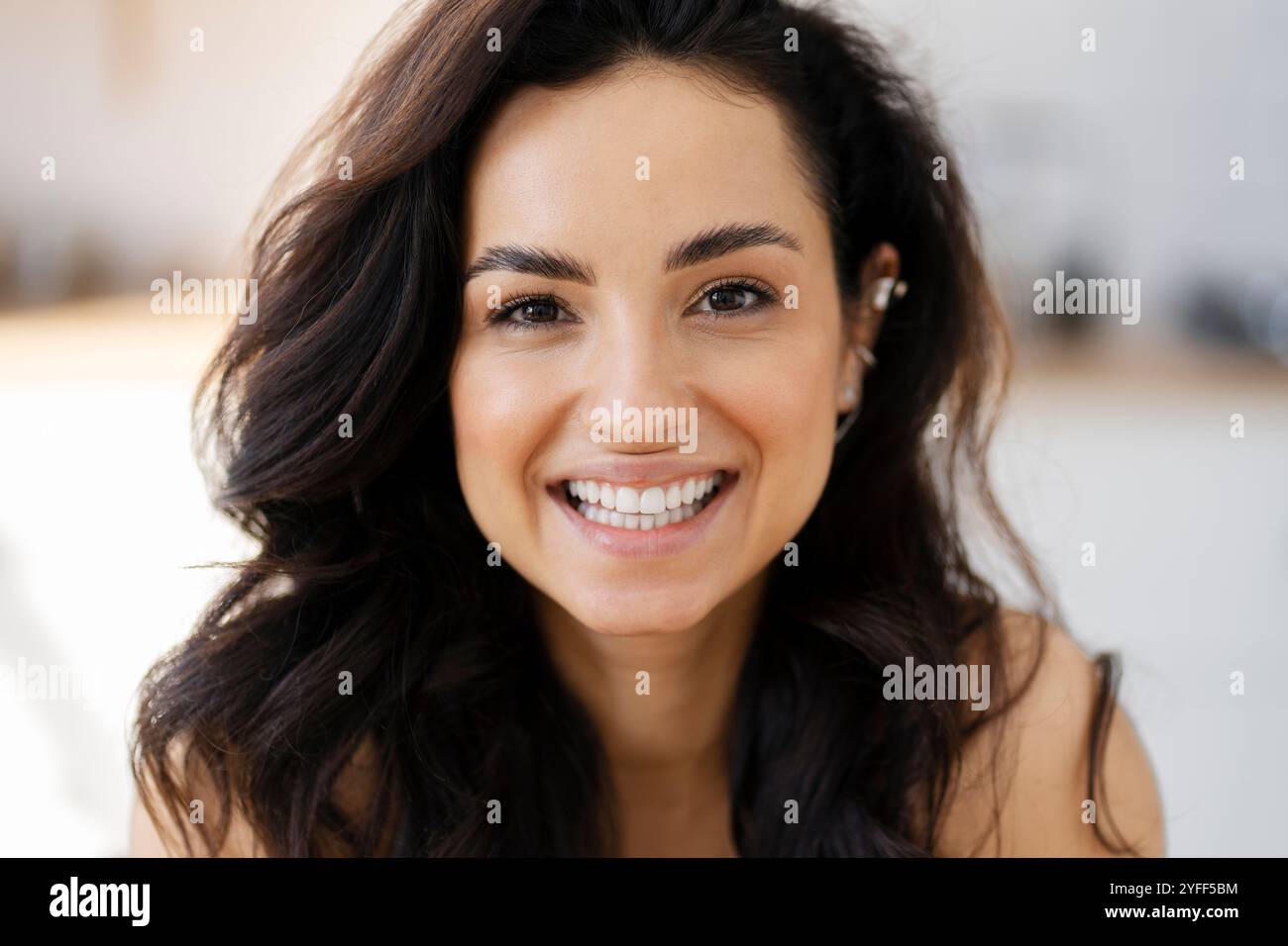Young woman with long, dark hair is smiling broadly, showing off her perfect white teeth Stock ...