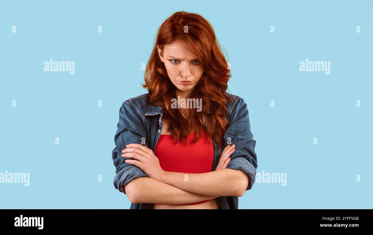 Sulky Teen Girl Crossing Hands Over Yellow Studio Background Stock ...