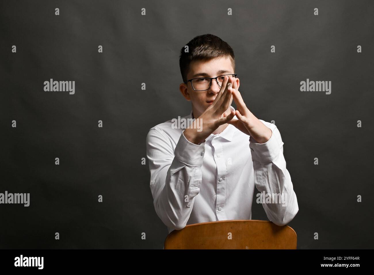 The young leader folded his hands in a steeple gesture Stock Photo - Alamy