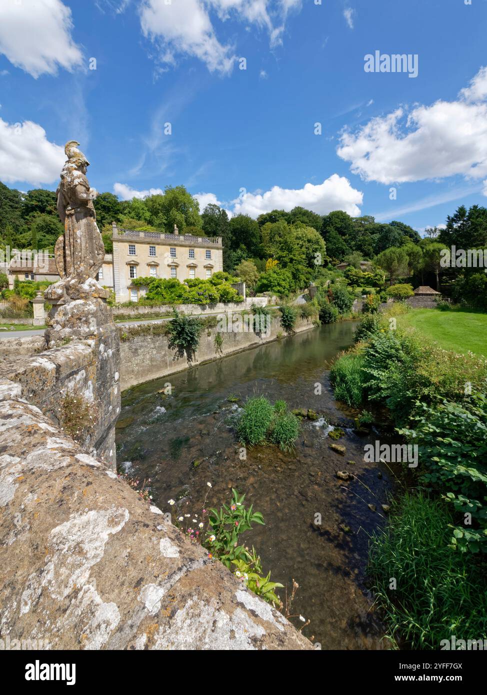 Statue of Britannia on a bridge over the River Frome with Iford Manor ...